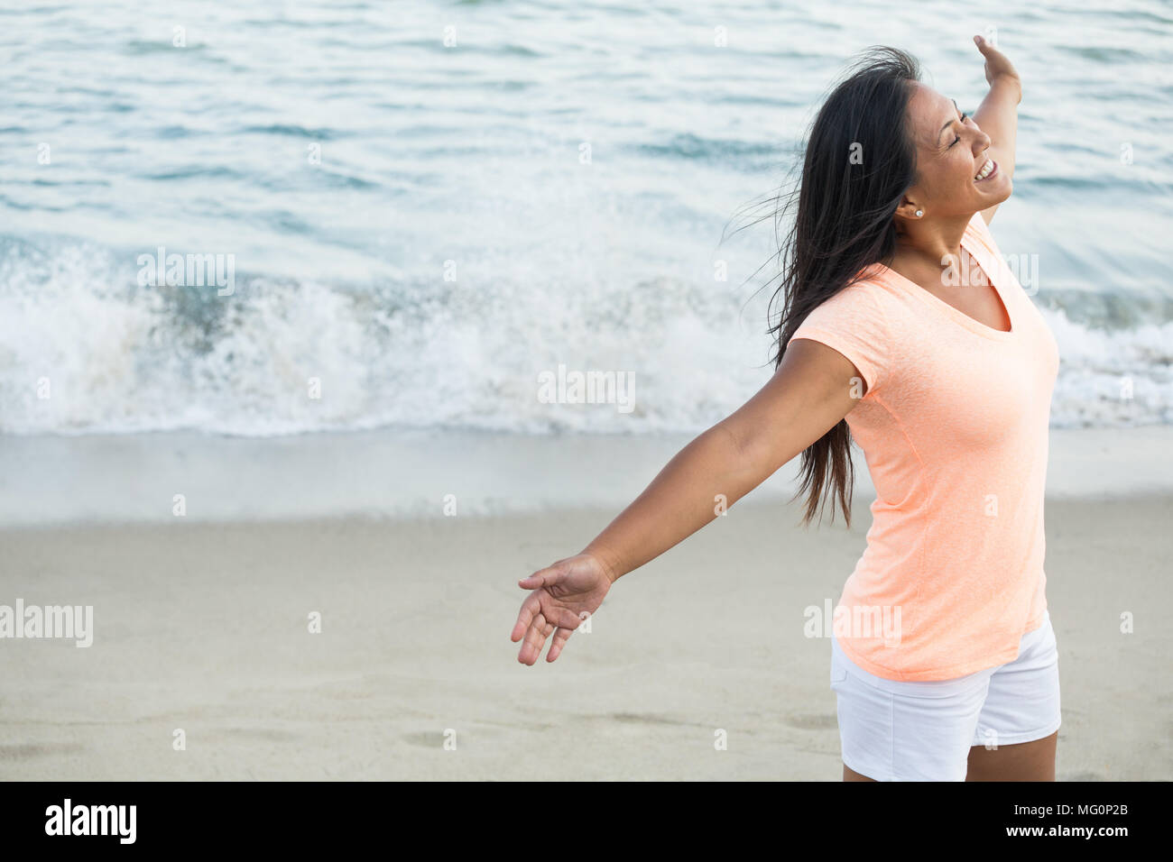 Asian woman with open arms Stock Photo - Alamy
