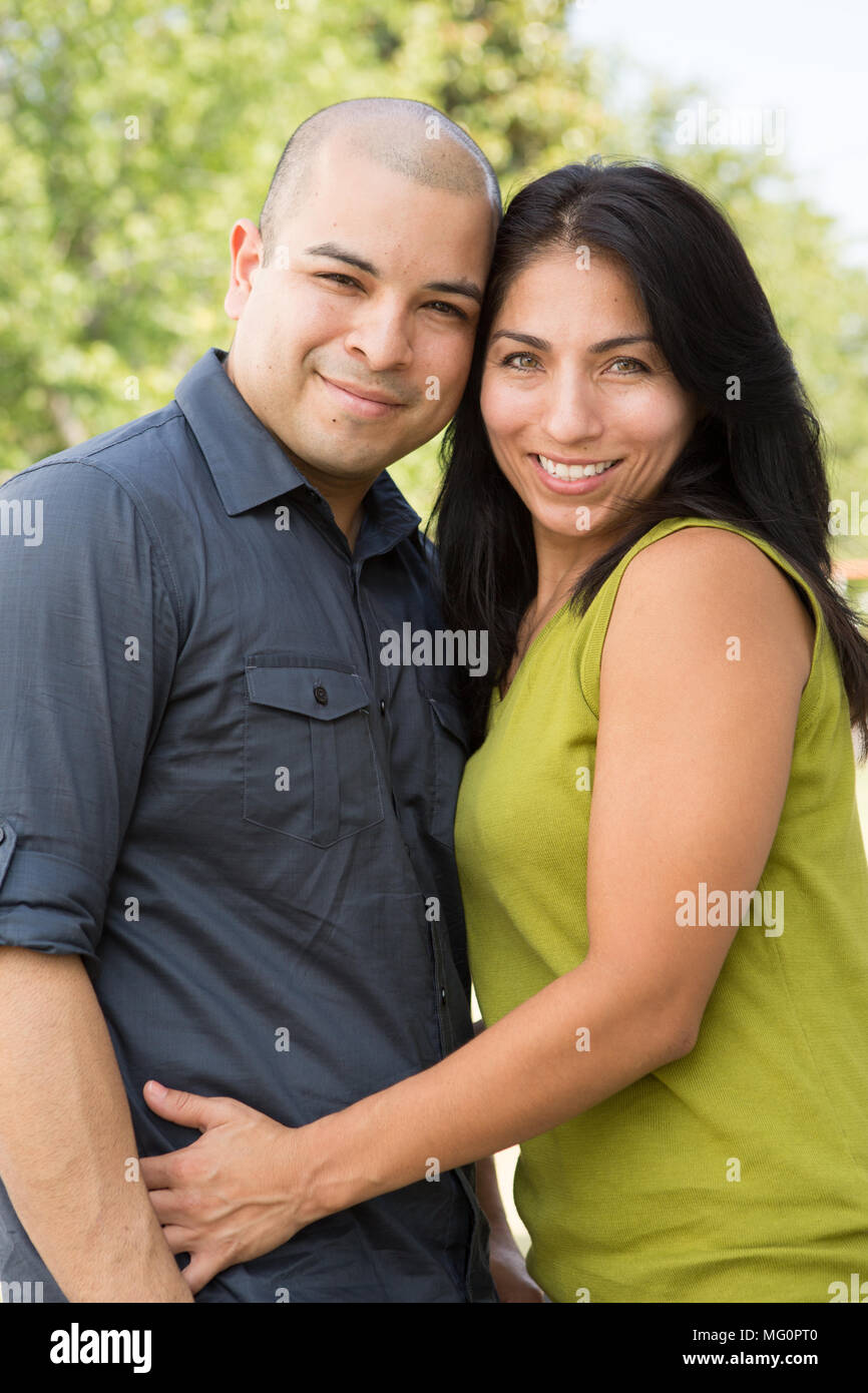 Young Hispanic couple smiling Stock Photo - Alamy