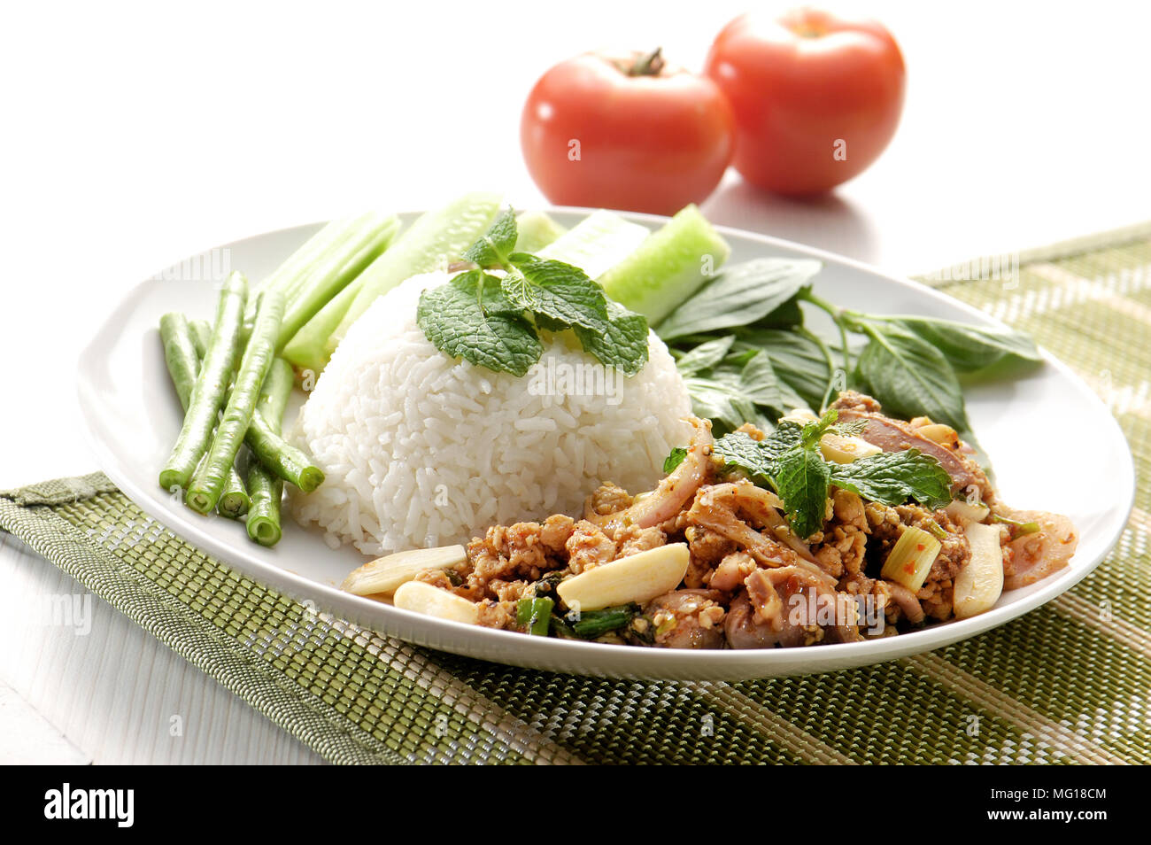 Chicken with rice and vegetables in background Stock Photo - Alamy