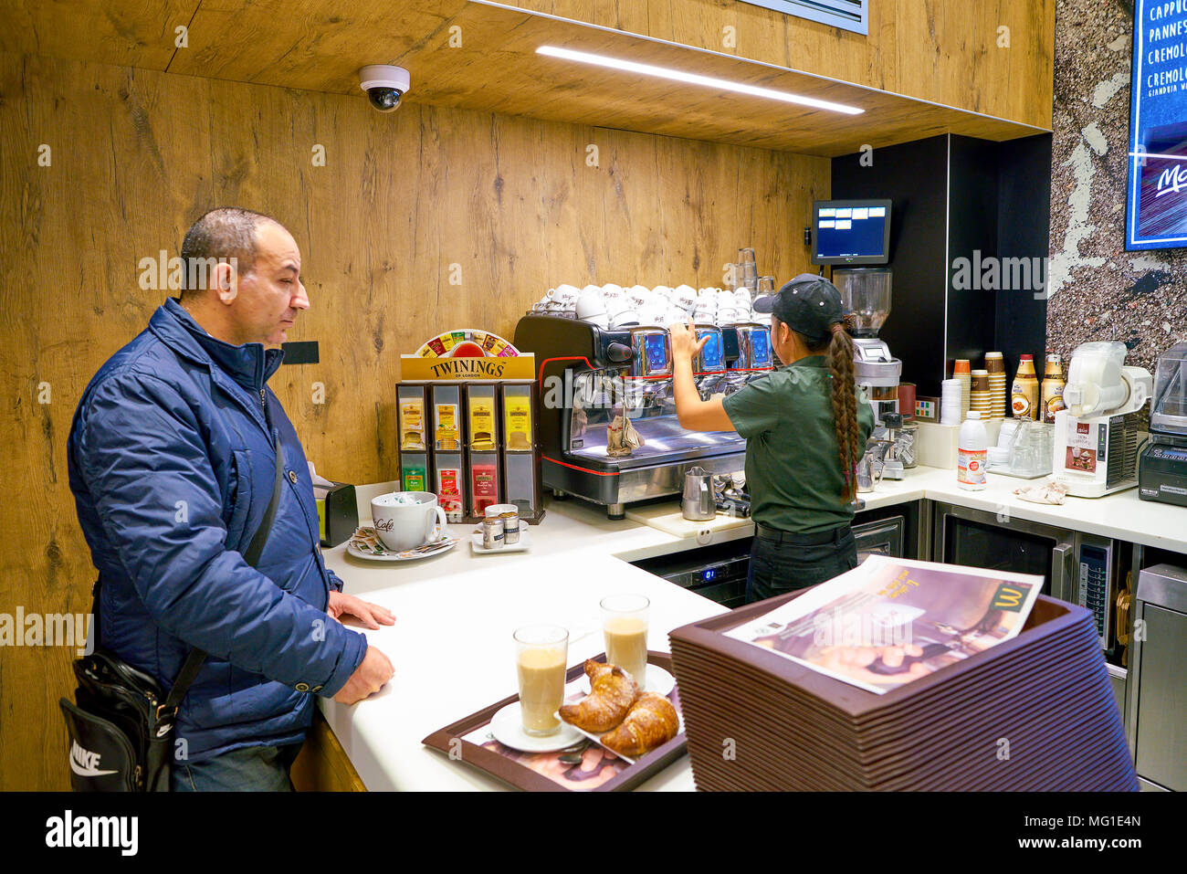 MILAN, ITALY - CIRCA NOVEMBER, 2017: worker at a McCafe coffee shop ...
