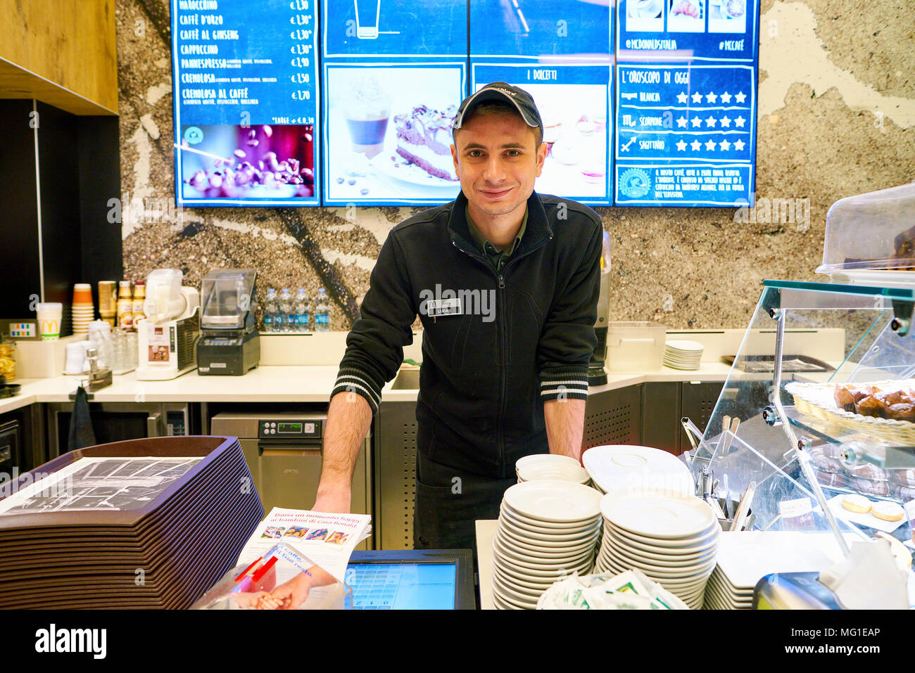 MILAN, ITALY - CIRCA NOVEMBER, 2017: worker at a McCafe coffee shop ...