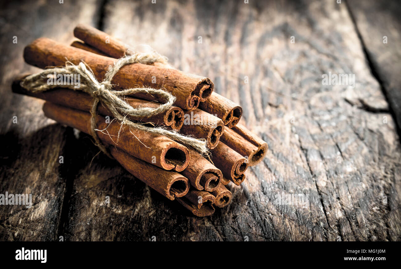 Cinnamon sticks . On the wooden background Stock Photo - Alamy