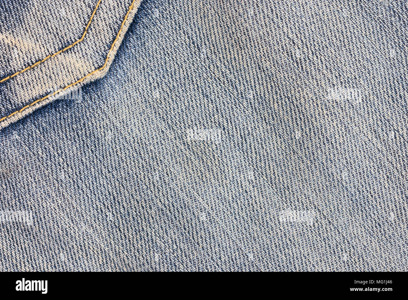 Abstract background and texture of jean. Denim pocket sewn with yellow ...