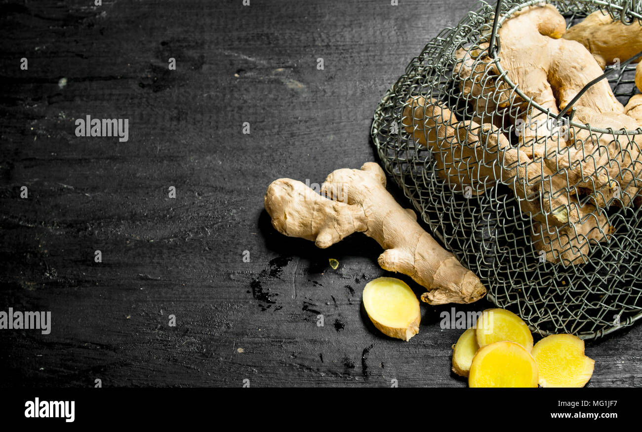 Fresh ginger in mesh bag. On the black chalkboard Stock Photo - Alamy