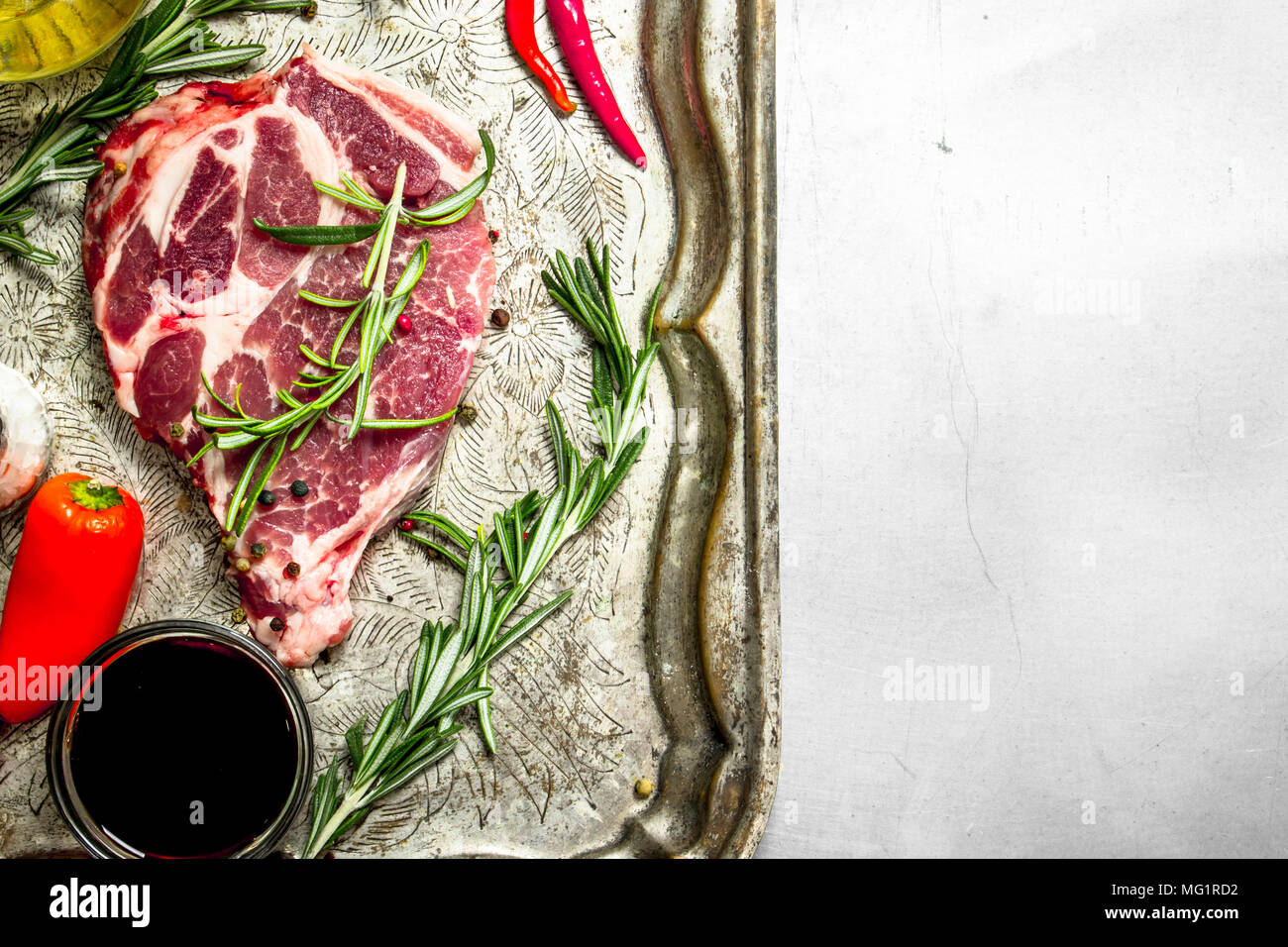Fresh raw beef meat with spices and herbs. On rustic background Stock ...
