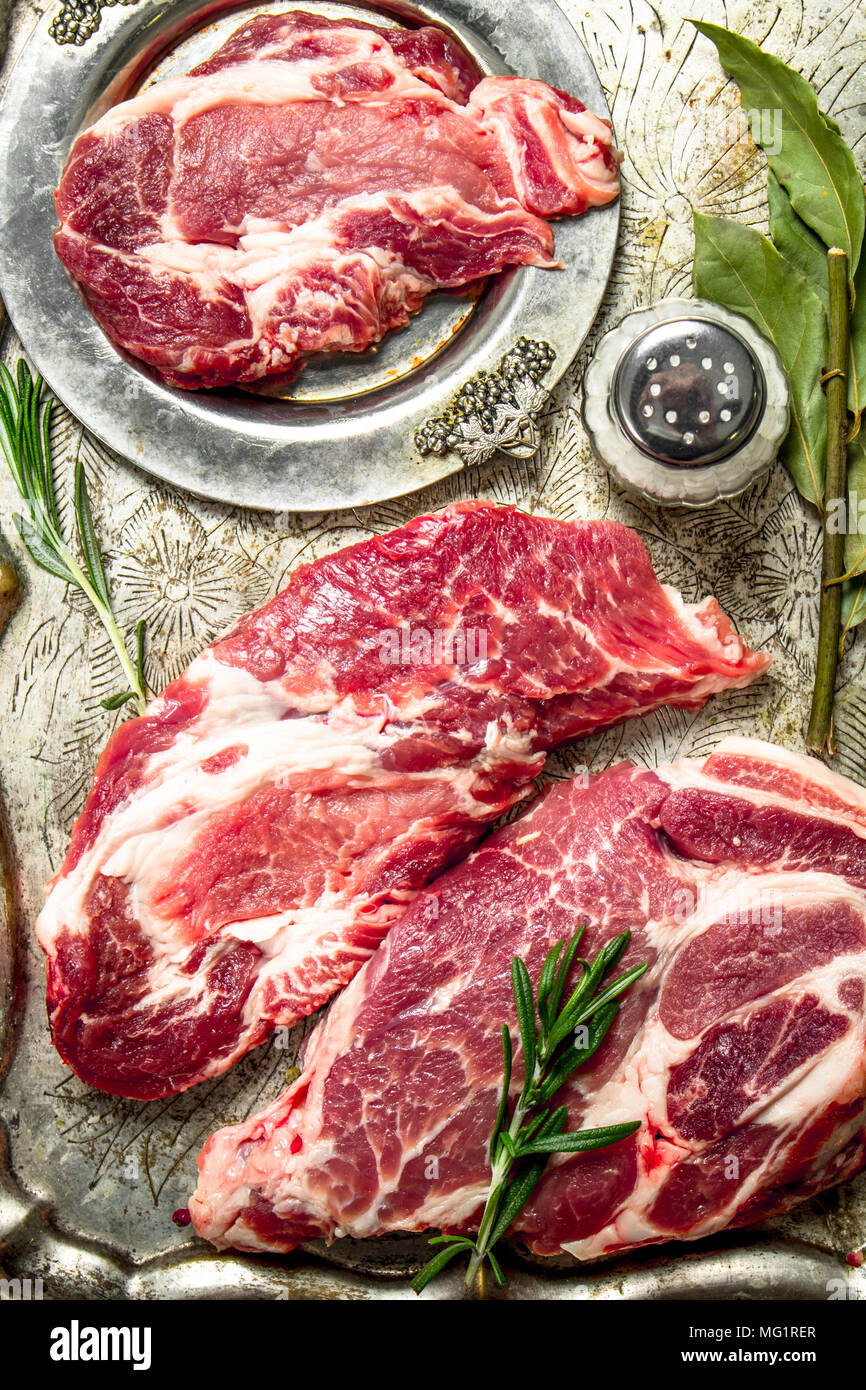 Fresh raw beef meat with spices and herbs. On rustic background Stock ...