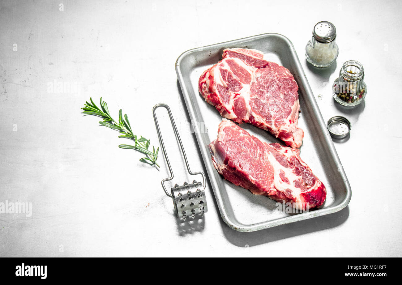Fresh raw beef steak with spices. On rustic background Stock Photo - Alamy