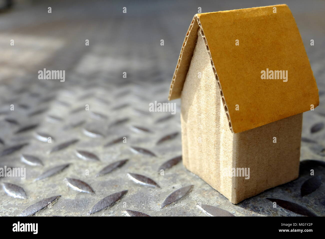 Close up Cardboard House on Dimond Metal Plate Stock Photo - Alamy