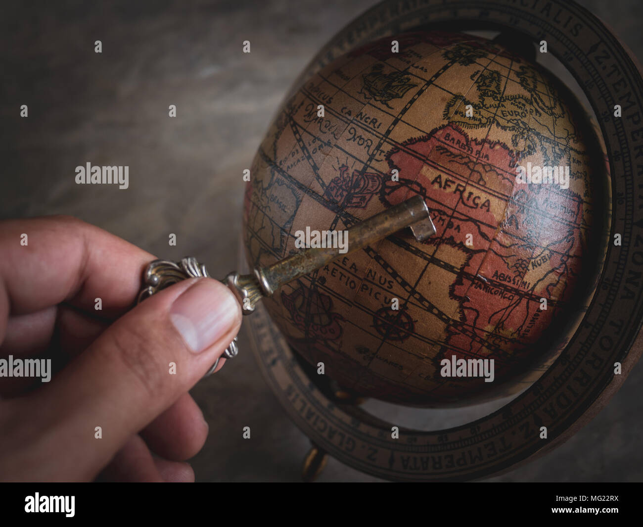 Hand Hoding The Antique Key point to The Africa Map on The Old Wooden ...