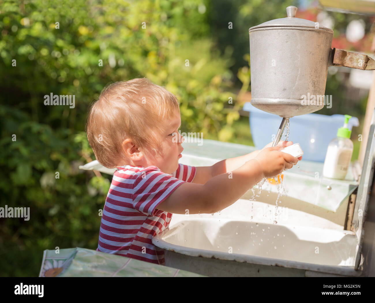 Child washing face outside hi-res stock photography and images - Alamy