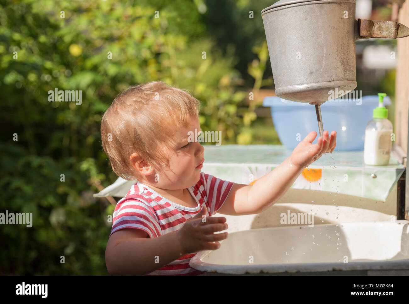 Child washing face outside hi-res stock photography and images - Alamy