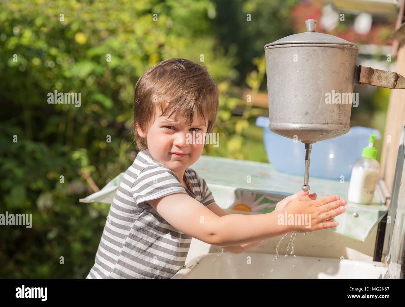 Child washing face outside hi-res stock photography and images - Alamy