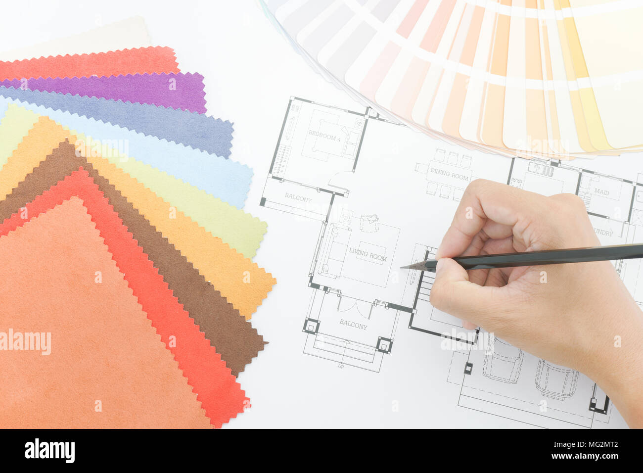 Close up hand writing on architectural drawing with color pallette and ...