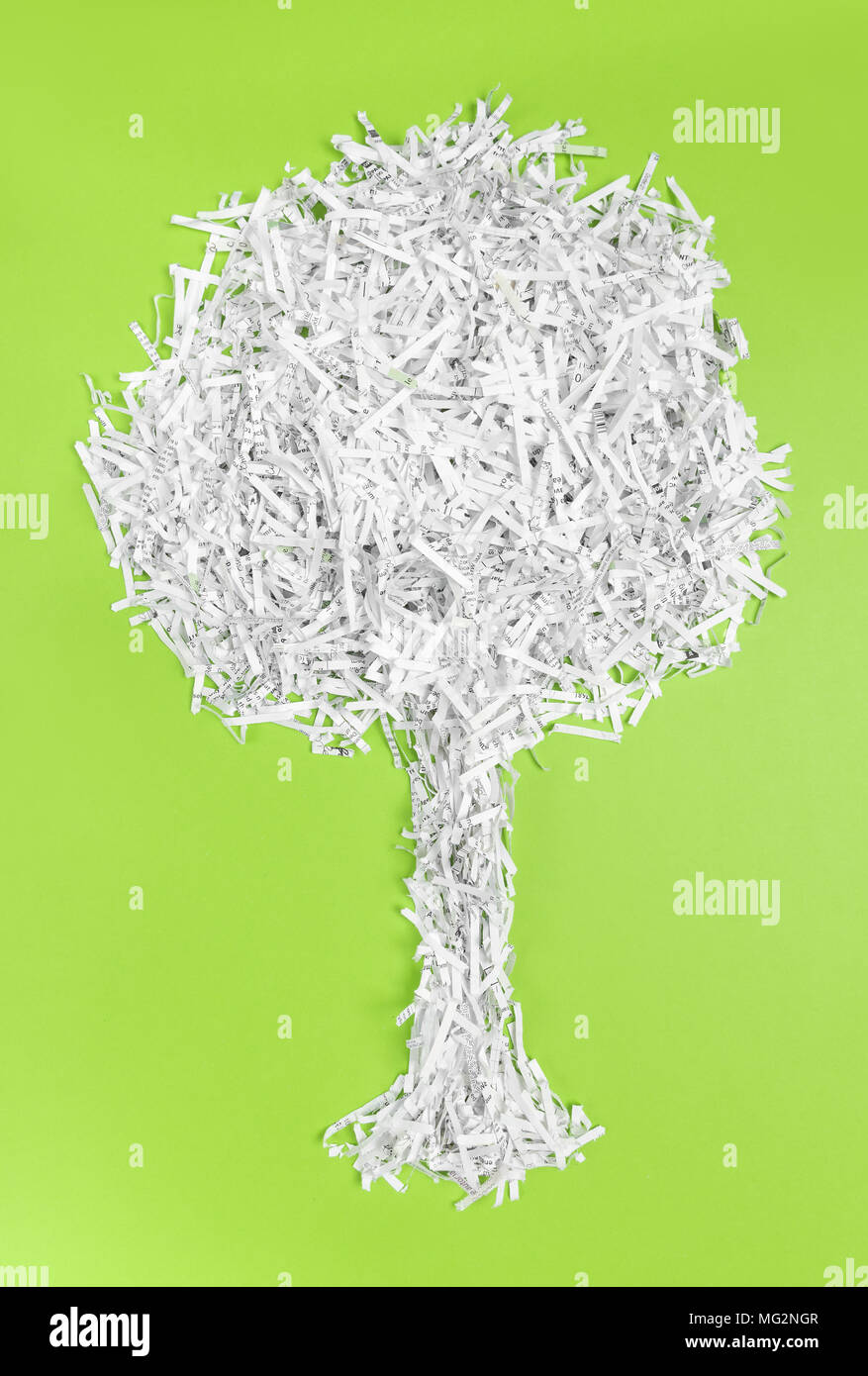 Tree made of shredded paper, on bright green background. Recycling and ...