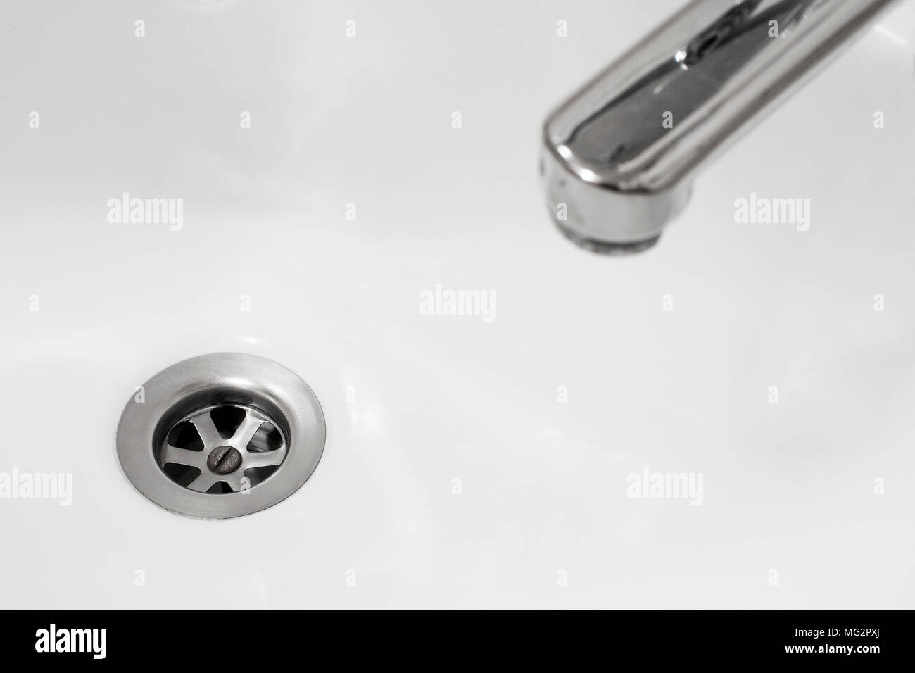 View of the sink drain and water tap. Close up photo of water drain ...
