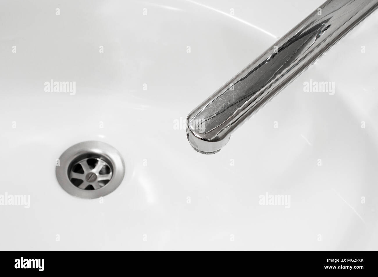 View of the sink drain and water tap. Close up photo of water drain ...