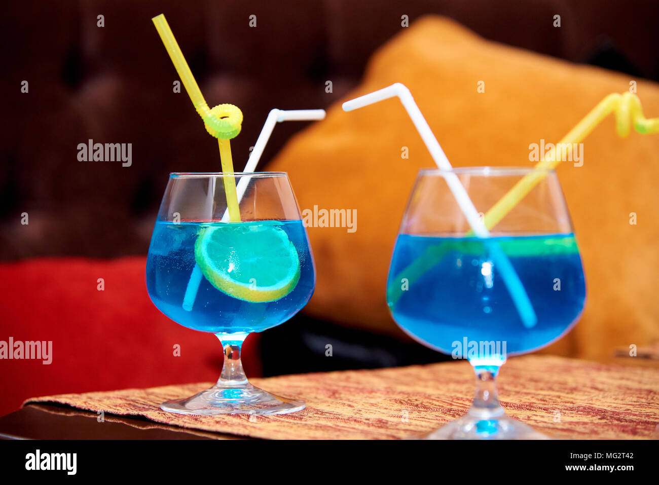 Blue cocktails with lemon and straws on a colorful background Stock ...