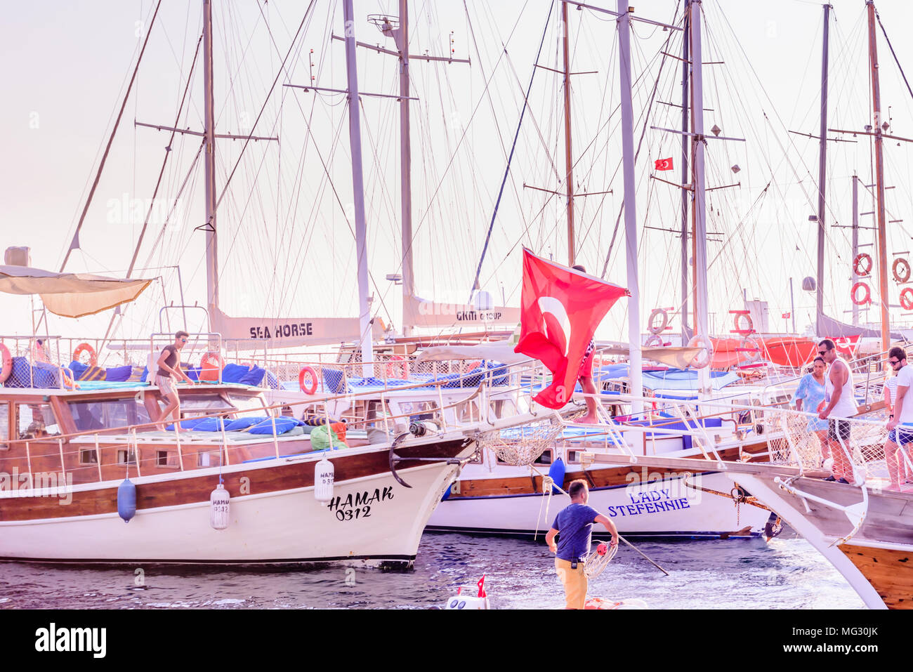 Unidentified people go sailing or boat tour at marine in Bodrum harbor ...