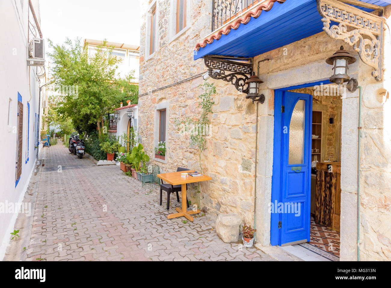 Narrow streets of Bodrum with cafe table and chairs in Bodrum,Turkey.23 ...