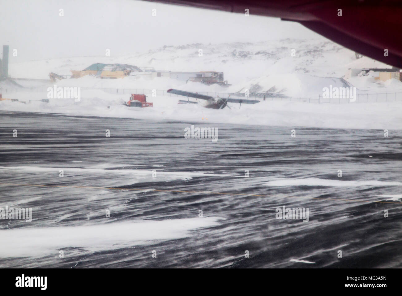 Aircraft on the ground in the snow of a blizzard at Iqaluit airport ...