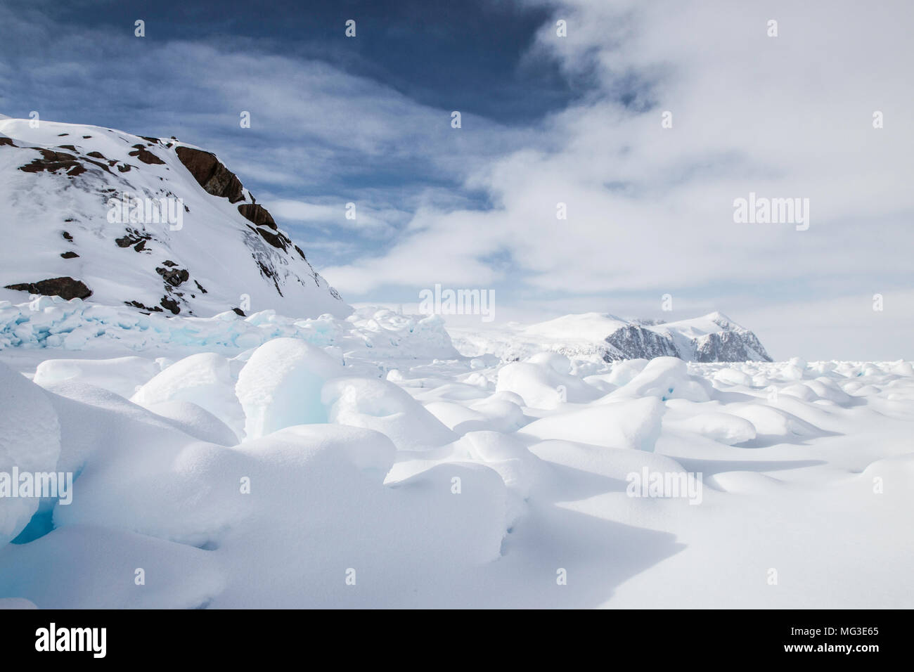 Lone photographer infront of a panoramic landscape of fjord and ...