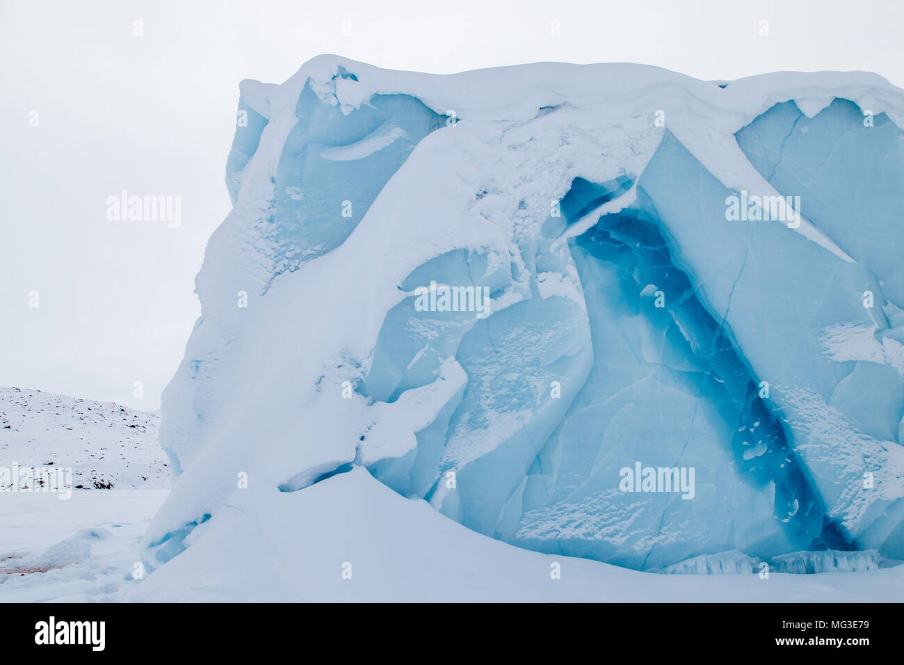 Dark blue compressed ice in the middle of an iceberg. Baffin Island ...