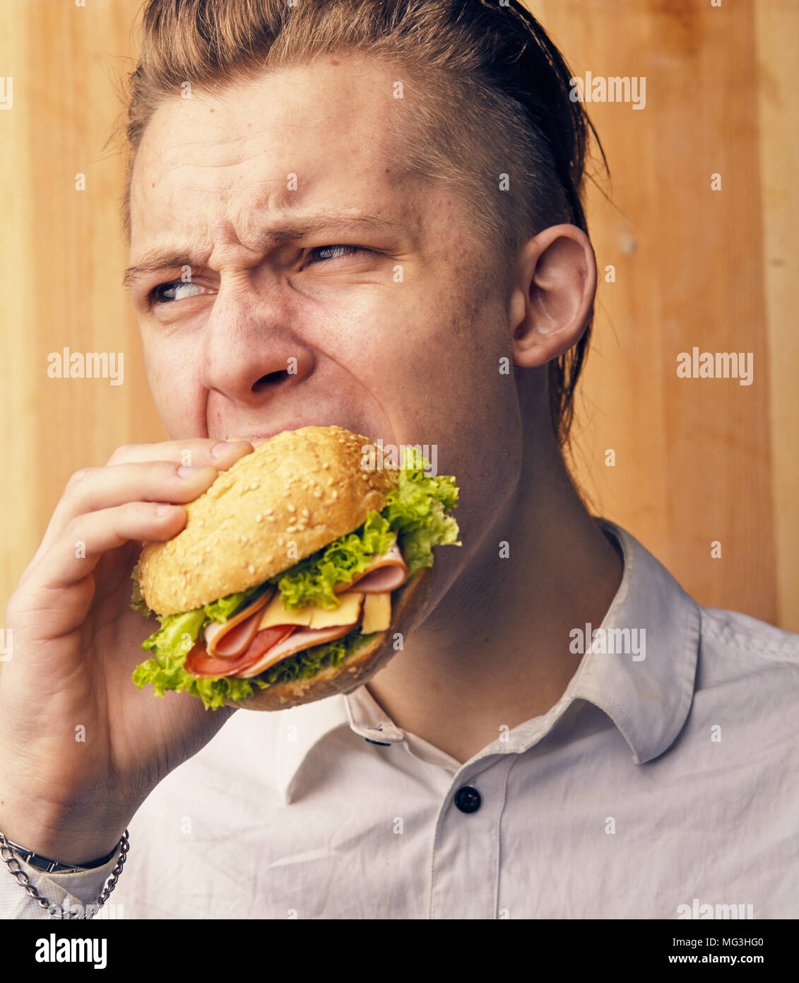 the young guy is really trying to burger Stock Photo - Alamy