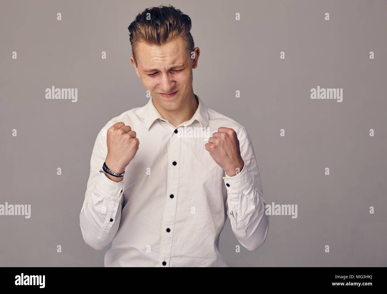 a young man demonstrates a sign of success Stock Photo - Alamy