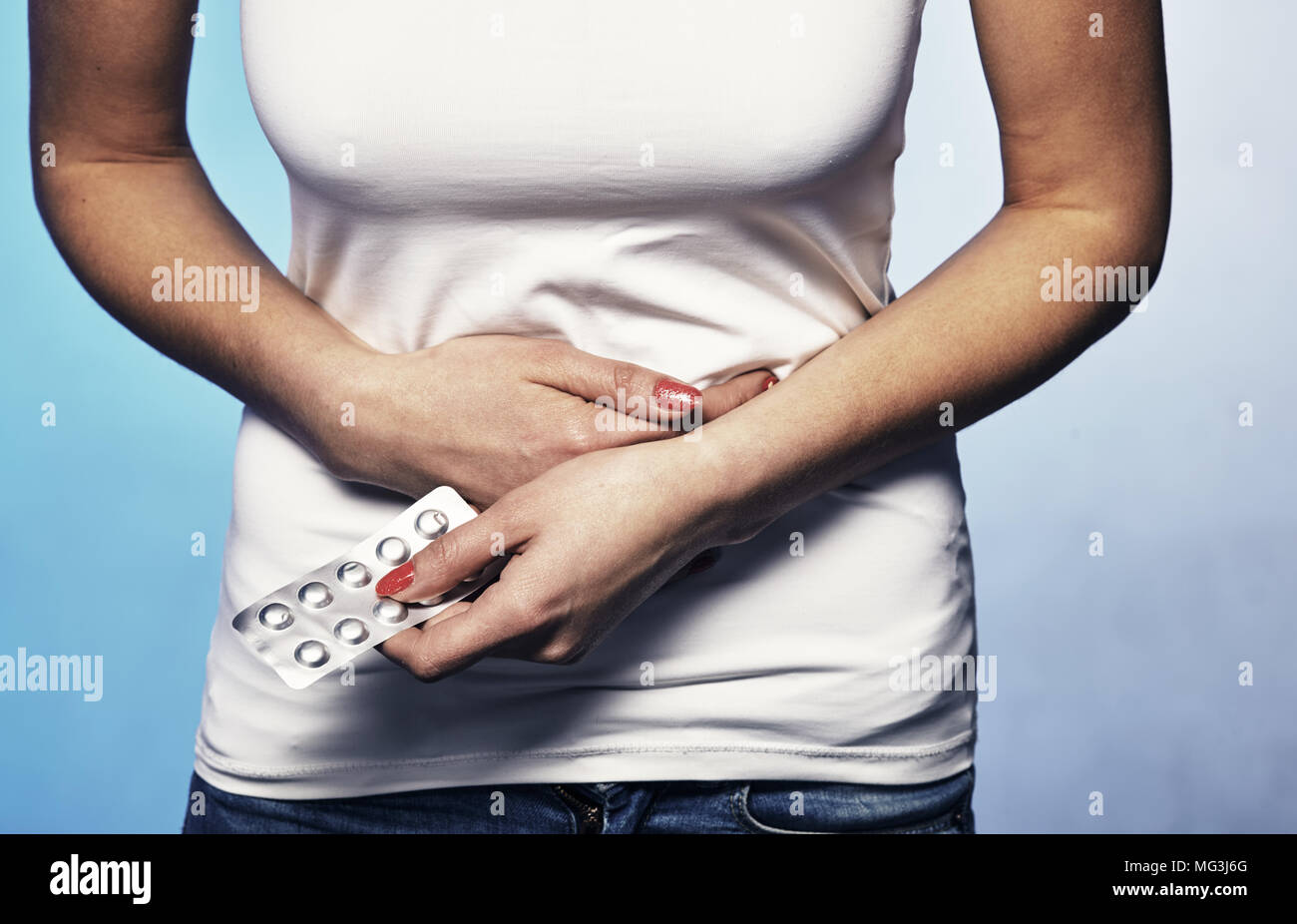 Female suffering from strong stomach ache abdominal pain. Health care ...