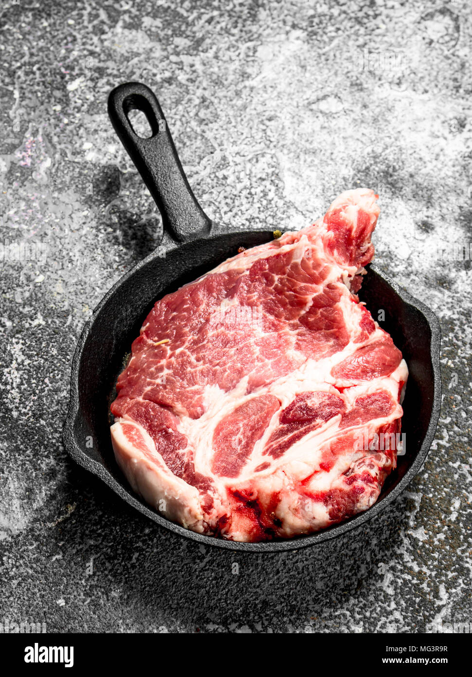 Raw beef steak in a pan. On rustic background Stock Photo - Alamy