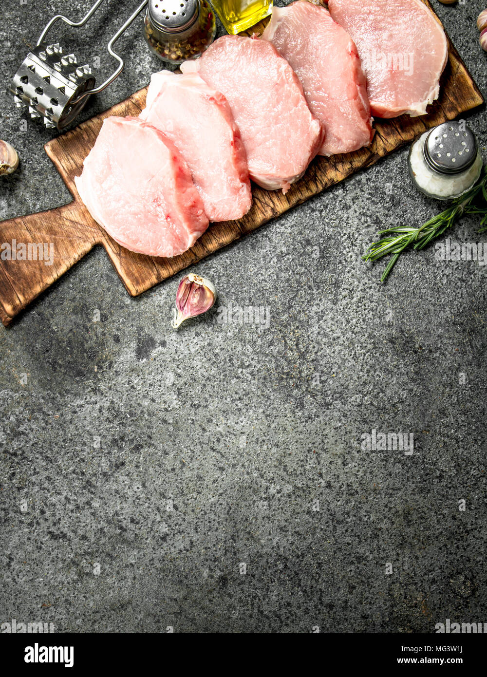 Raw pork steaks with herbs and spices. On rustic background Stock Photo ...