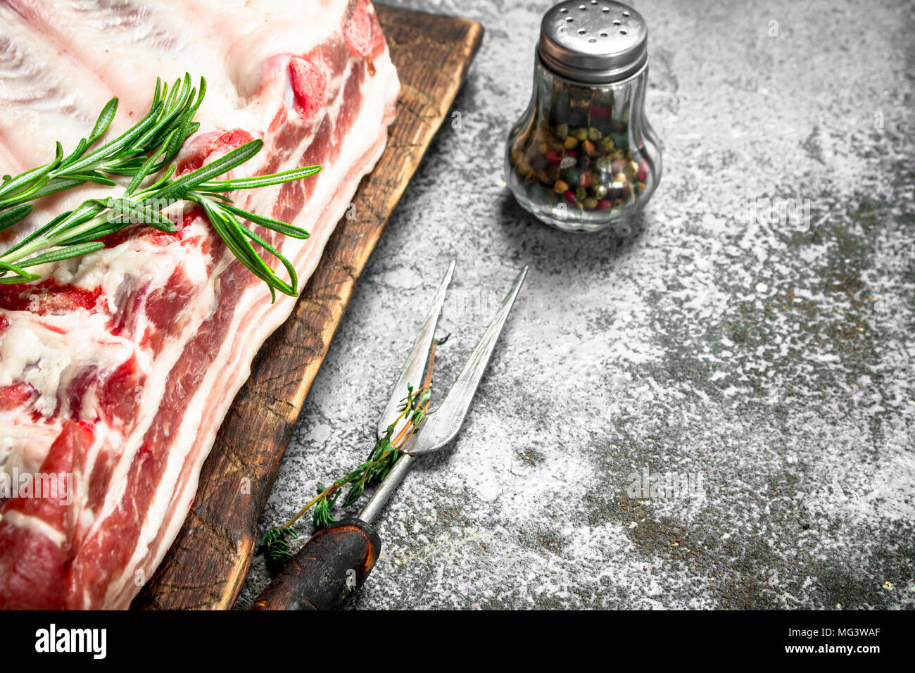 Raw pig ribs with herbs and spices. On rustic background Stock Photo ...