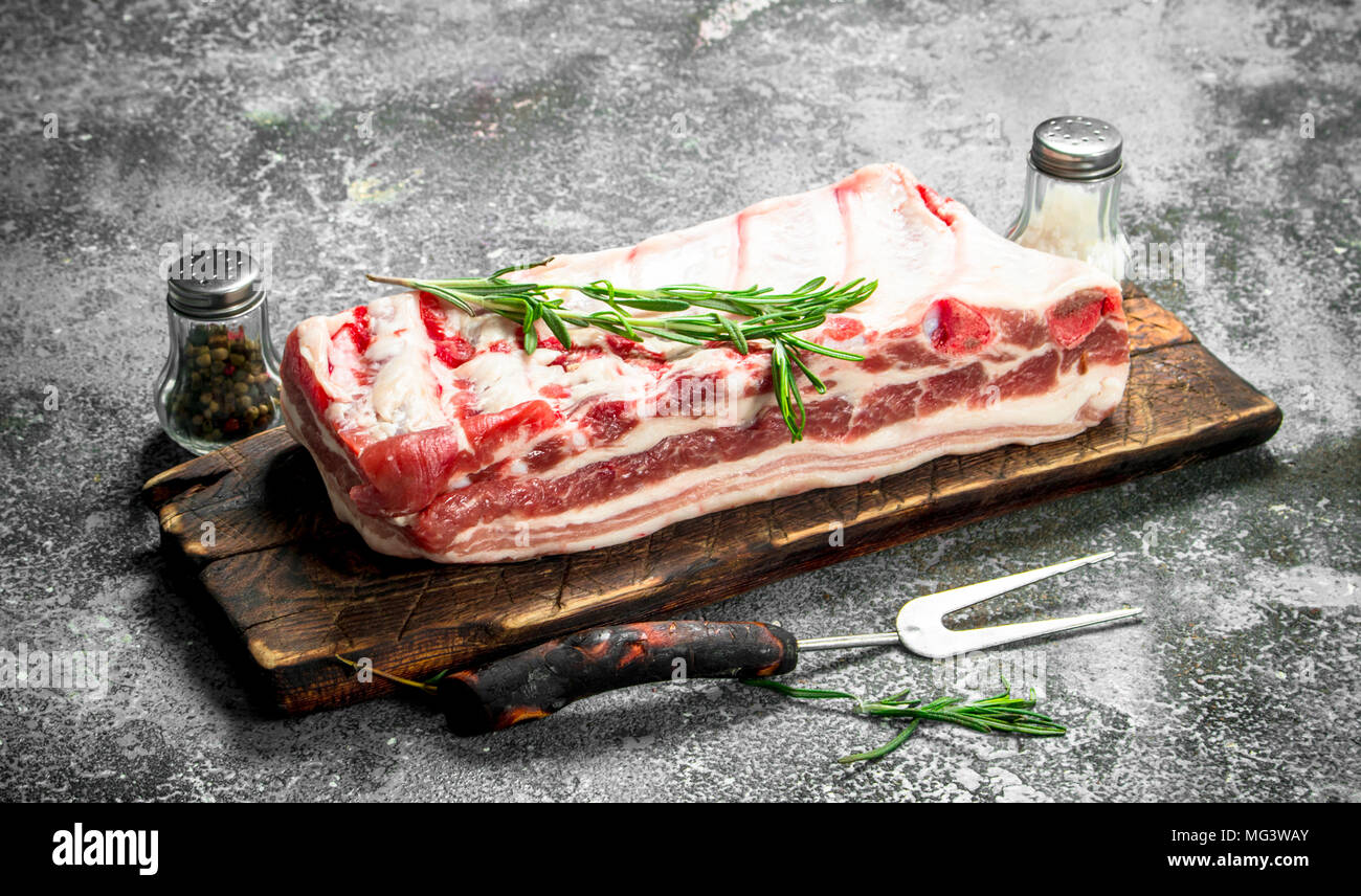 Raw pig ribs with herbs and spices. On rustic background Stock Photo ...