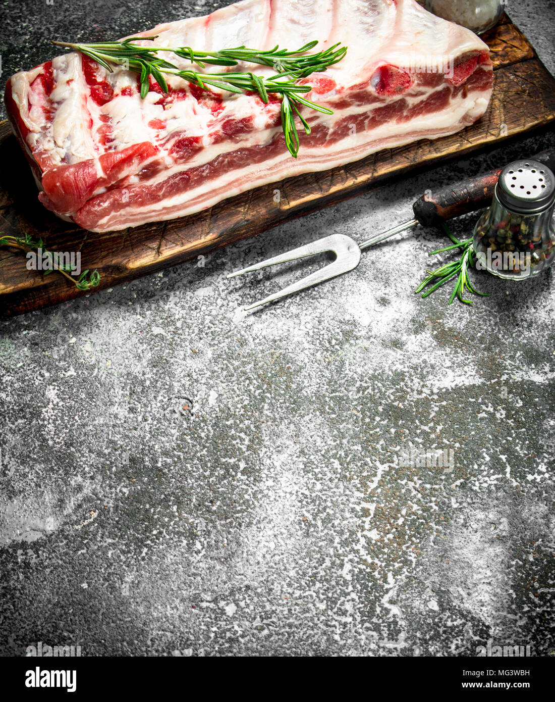 Raw pig ribs with herbs and spices. On rustic background Stock Photo ...