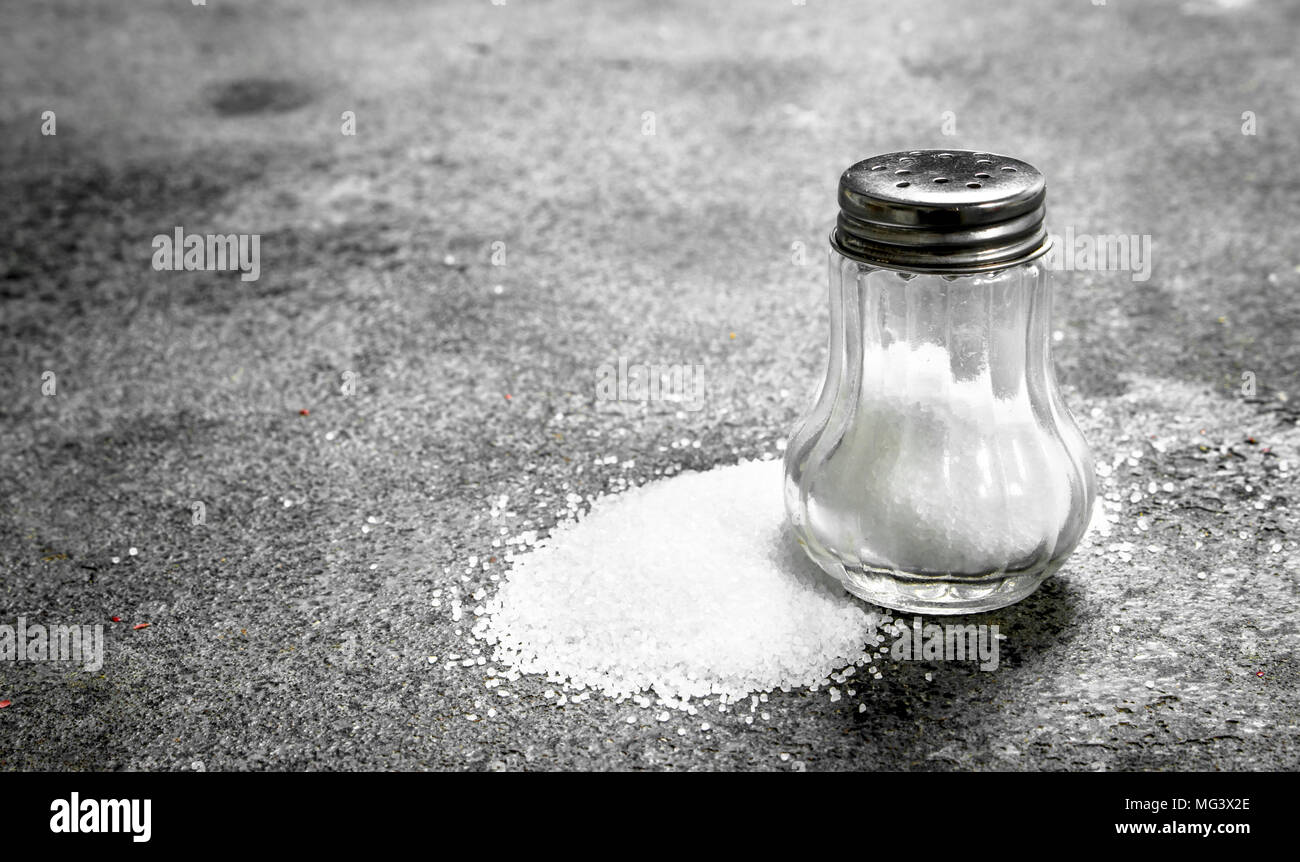 Salt in glass. On rustic background Stock Photo - Alamy