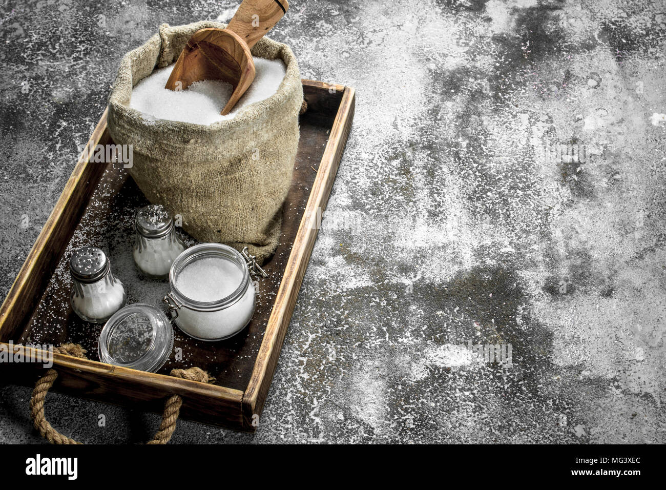 Salt in an old bag on a tray. On rustic background Stock Photo - Alamy