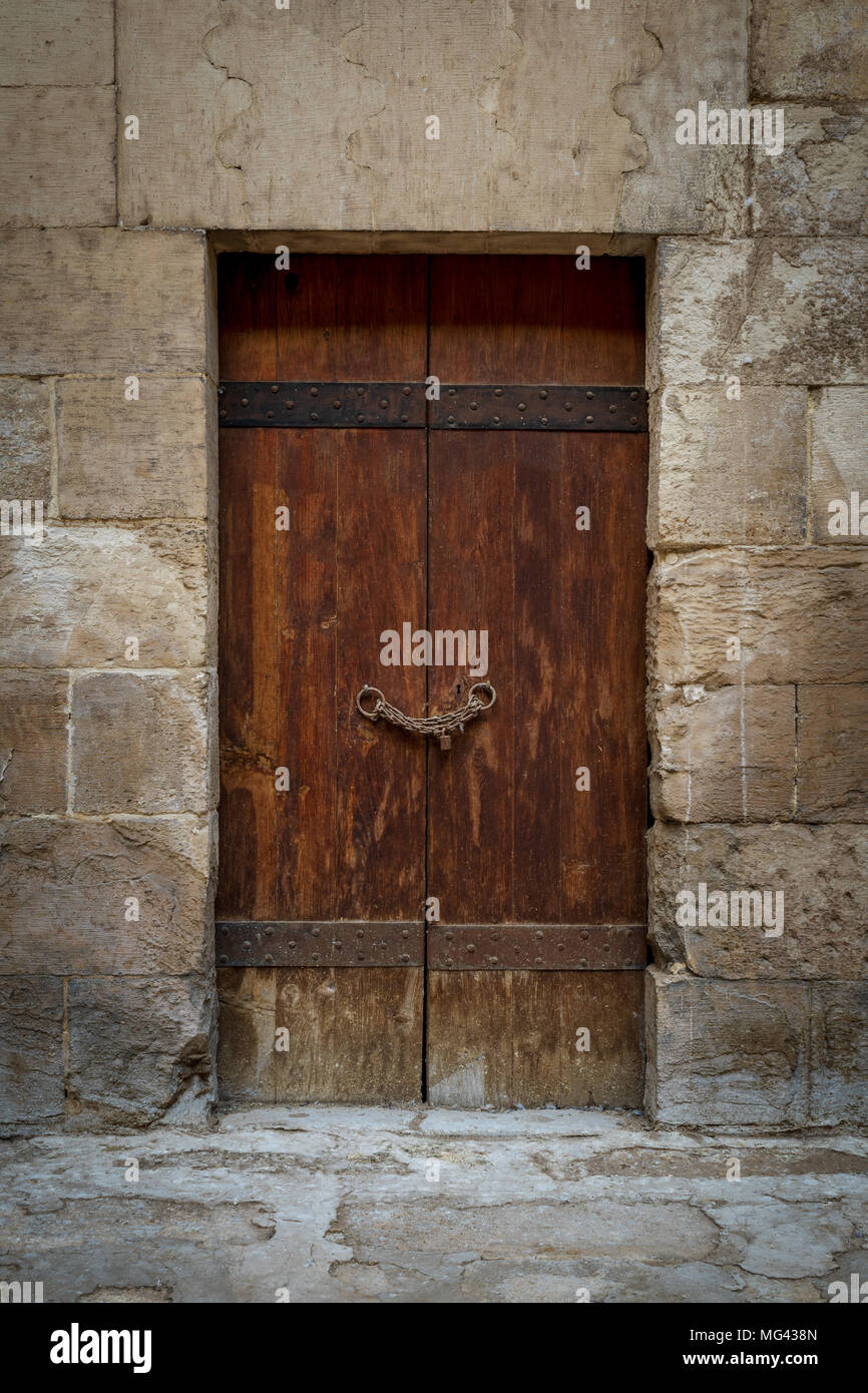Wooden aged door and stone bricks wall, Medieval Cairo, Egypt Stock ...
