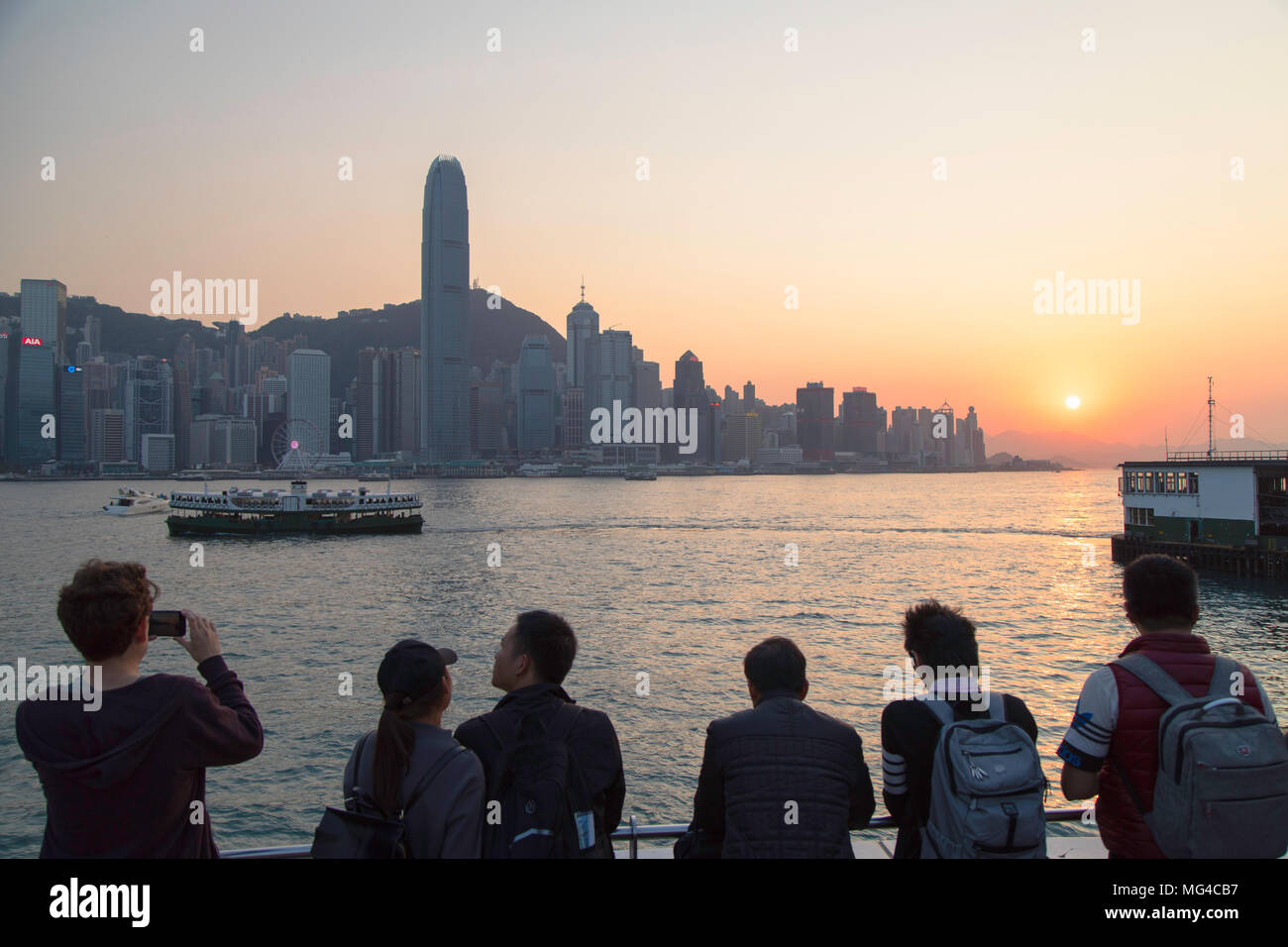 Star Ferry in Victoria Harbour at sunset, Hong Kong Island, Hong Kong ...