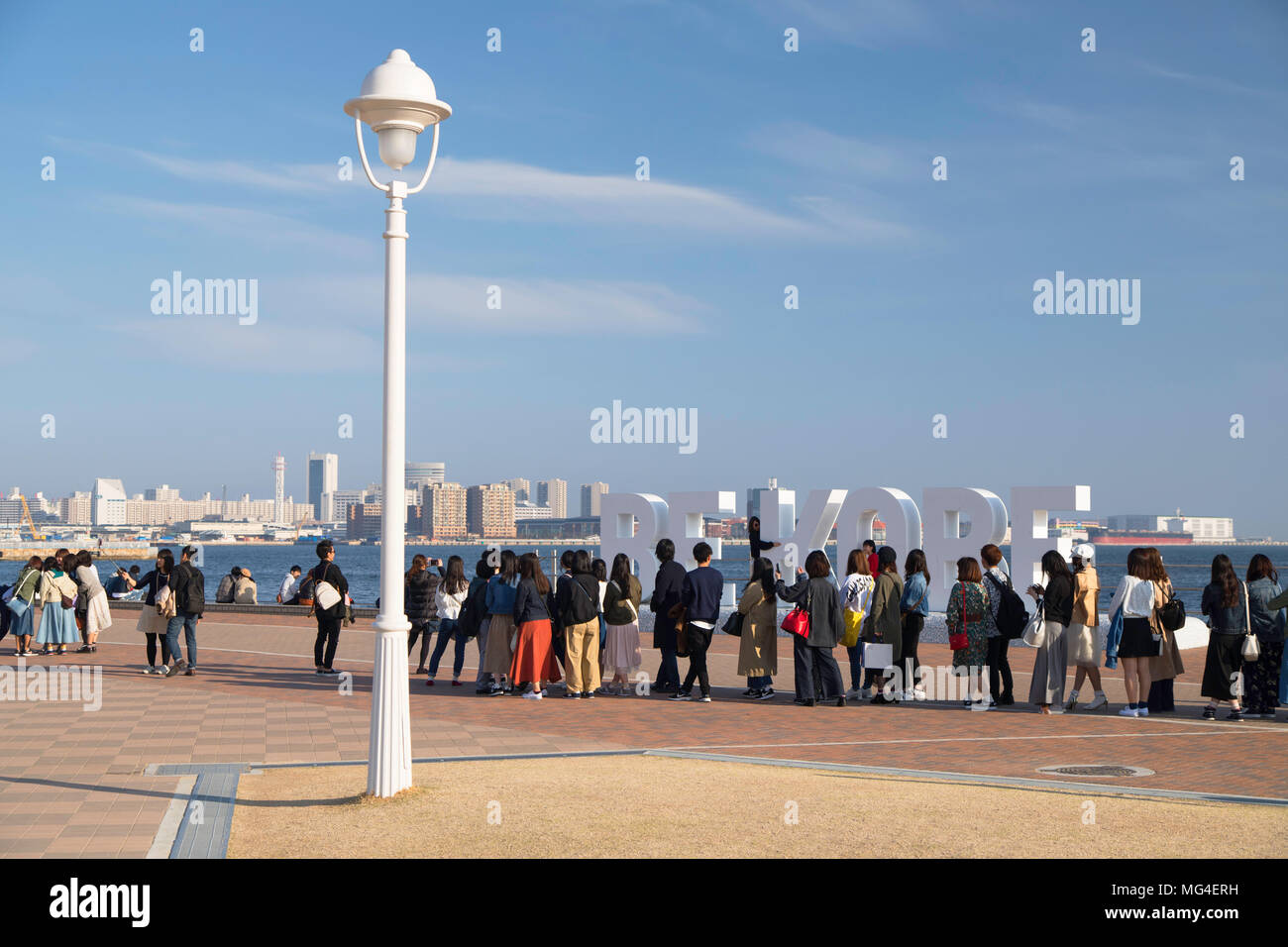 People posing in front of Kobe sign at harbour, Kobe, Kansai, Japan ...