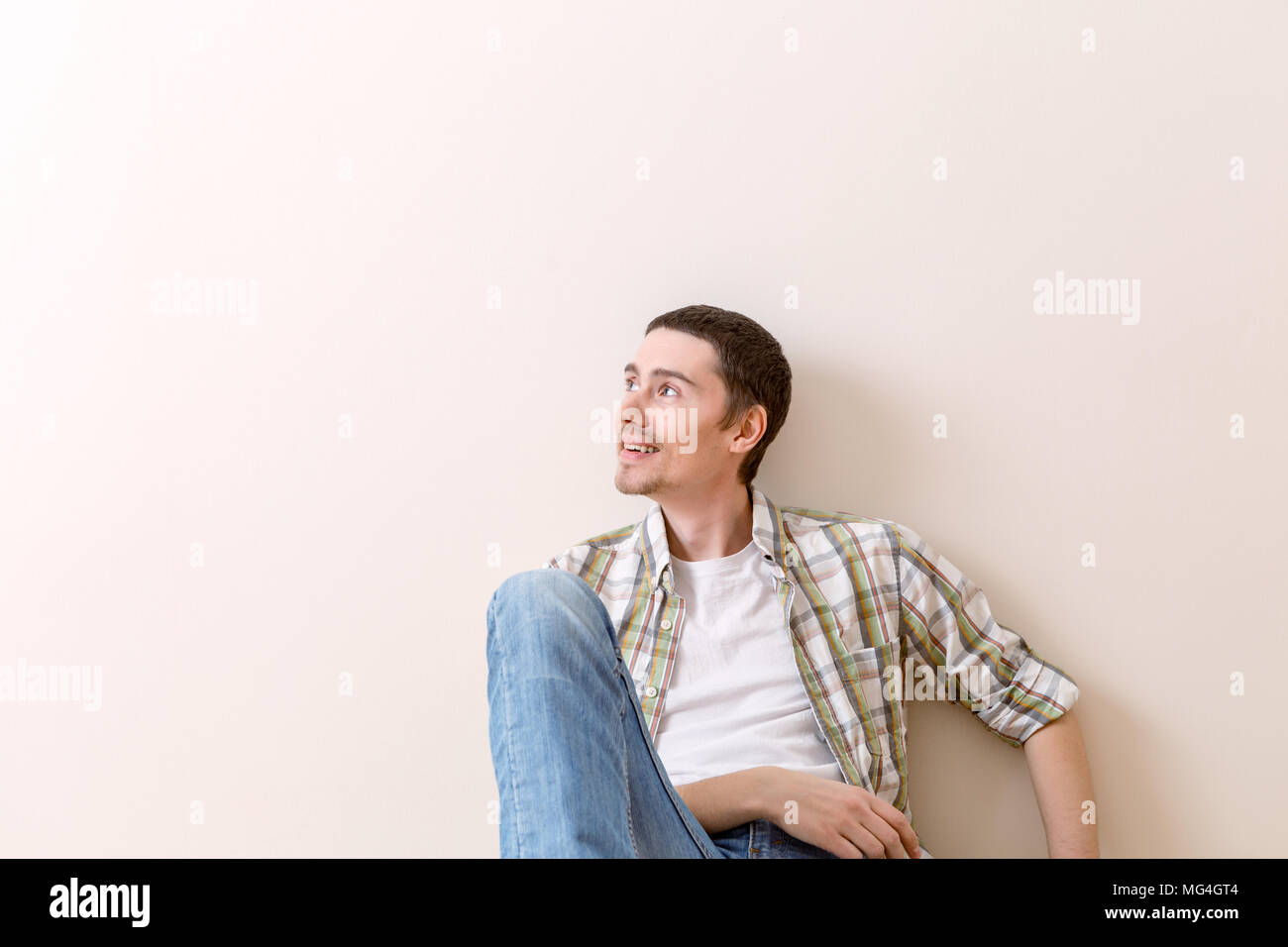 Photo of man sitting on floor Stock Photo - Alamy
