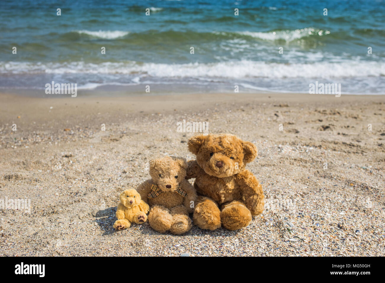 Happy family on vacation concept. Three brown teddy bears sitting like ...