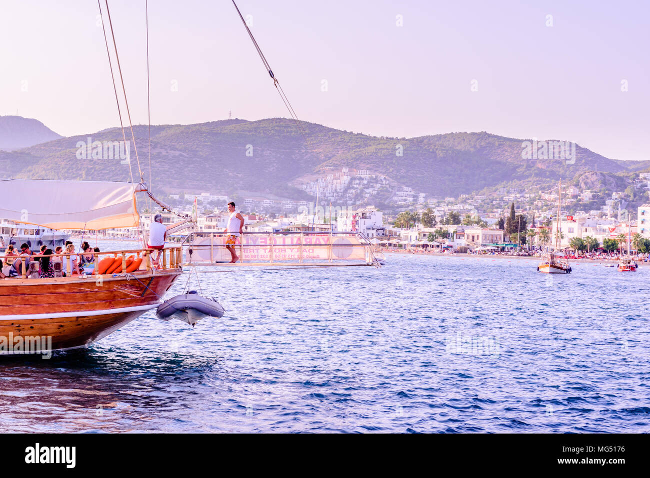 Unidentified people go sailing or boat tour at marine in Bodrum harbor ...
