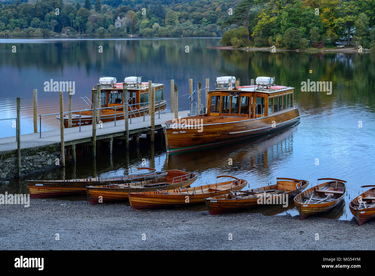 Motor launches and wooden rowing boats on the shore at Keswick landing ...