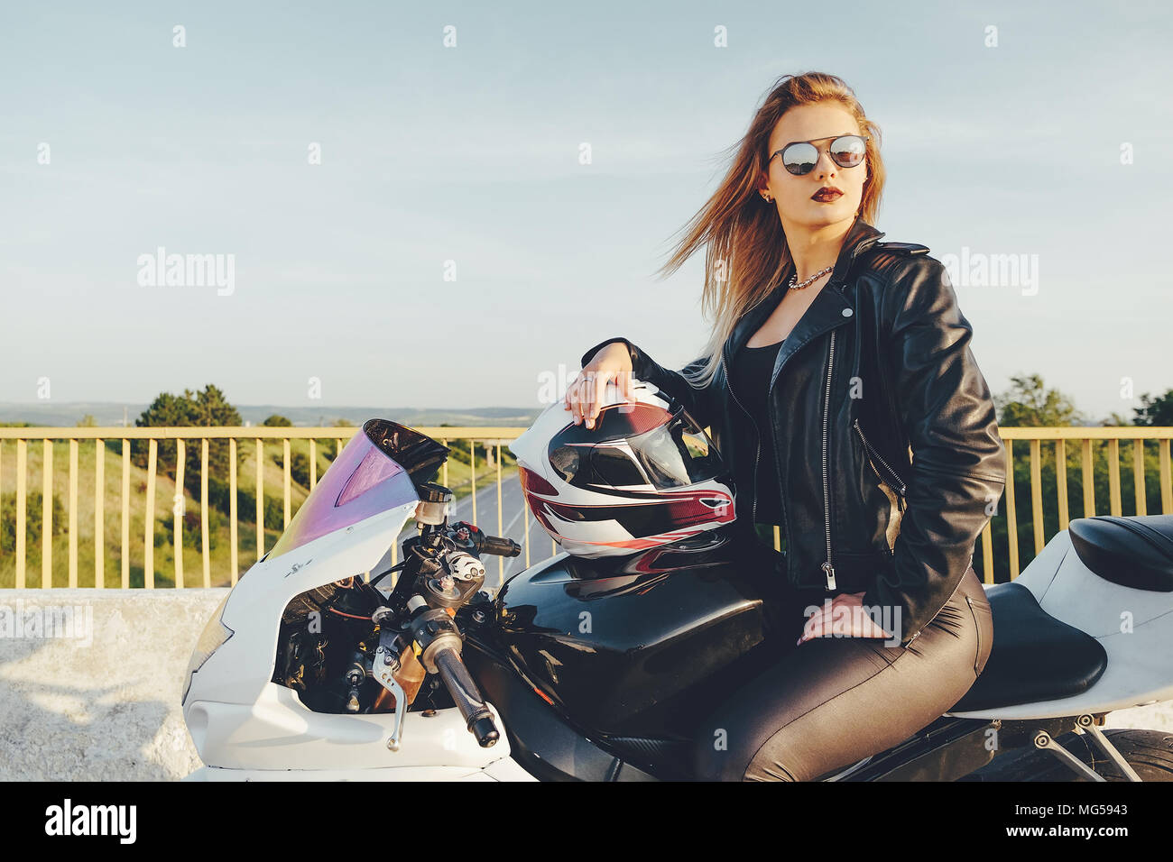 Woman posing on motorcycle hi-res stock photography and images - Alamy