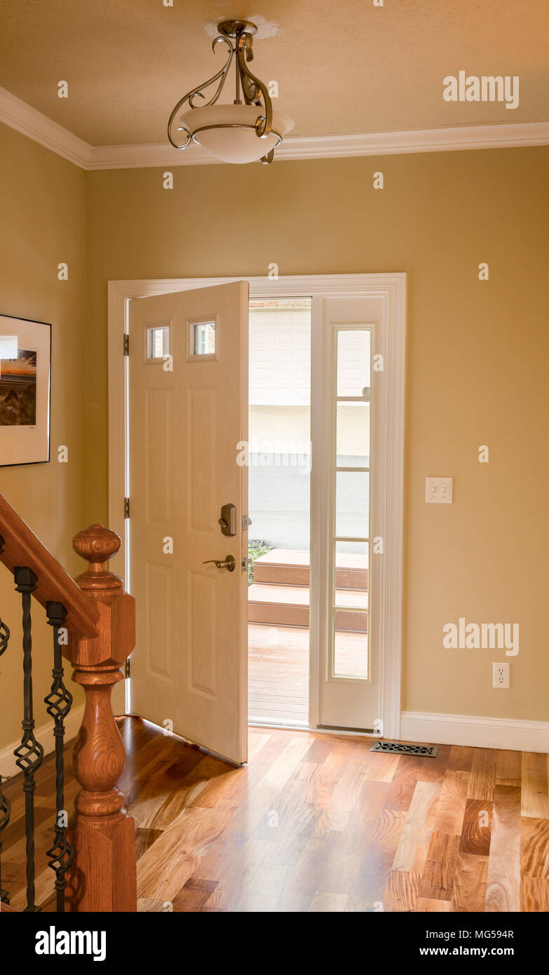 Front door and hall with wooden floor Stock Photo - Alamy