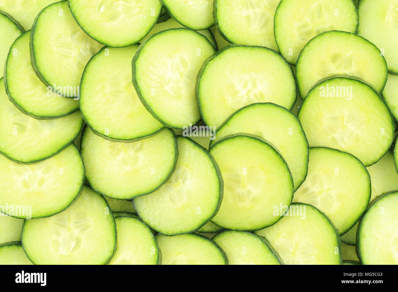 slices of fresh green cucumbers as a food background texture Stock ...