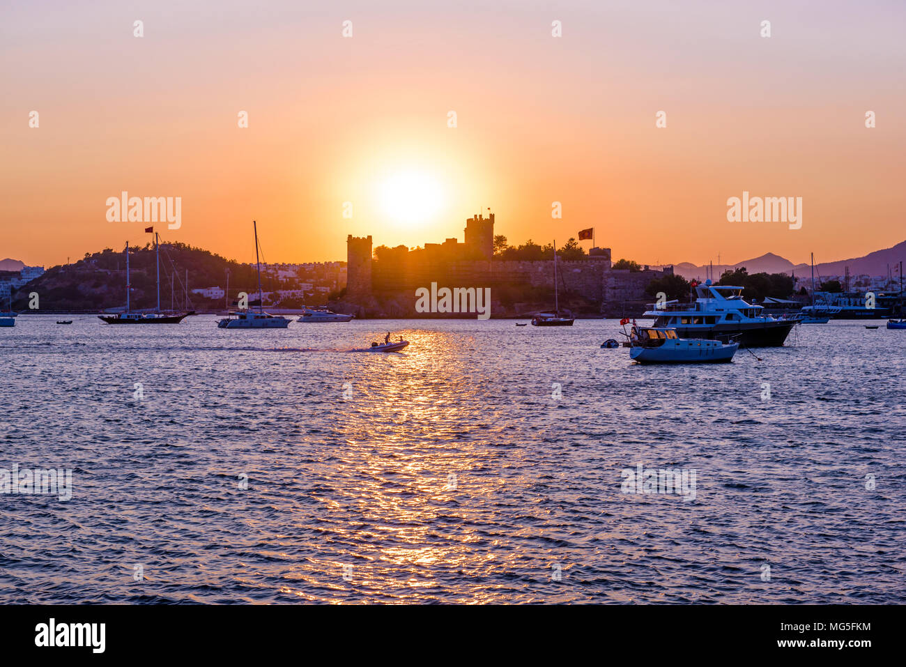 Sunset view of Bodrum Marine with yachts and St. Peter Castle or Bodrum ...