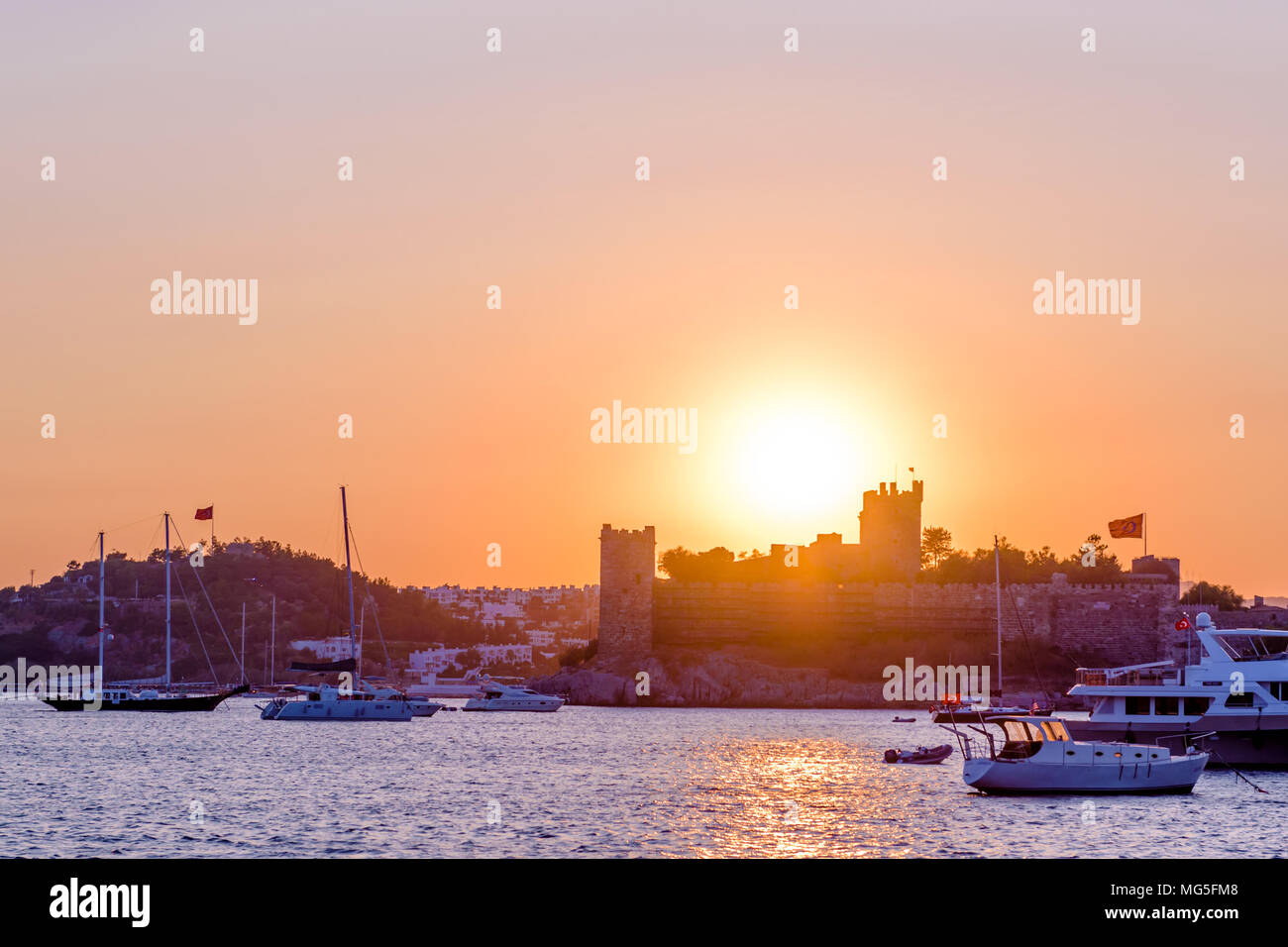 Sunset view of Bodrum Marine with yachts and St. Peter Castle or Bodrum ...