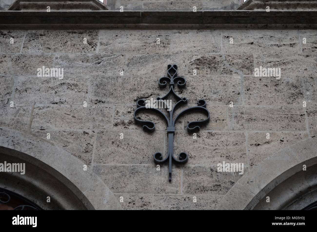 black ornament on a historic stone wall in horizontal format shot in ...