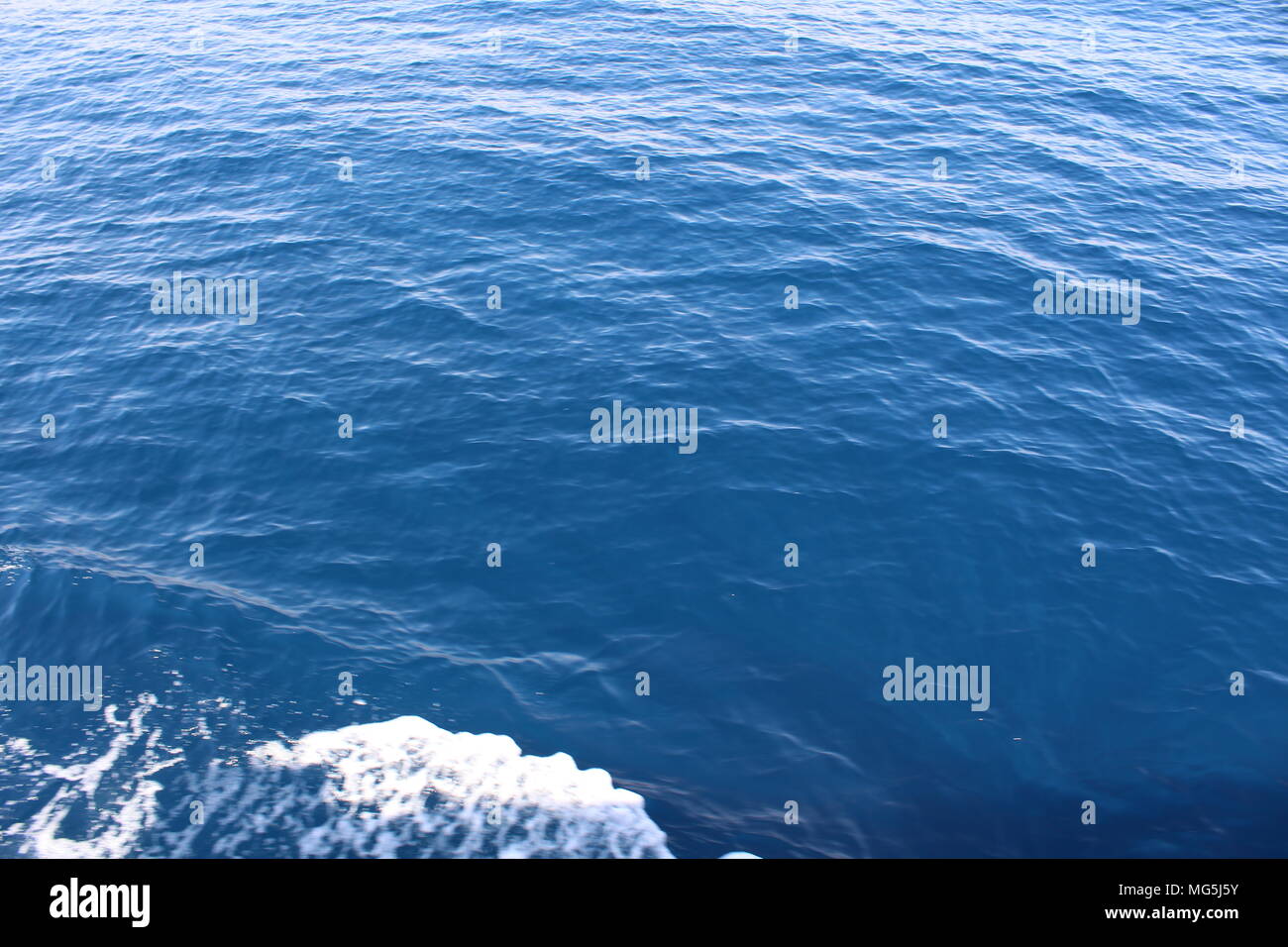 Background shot of aqua red sea water surface Stock Photo - Alamy
